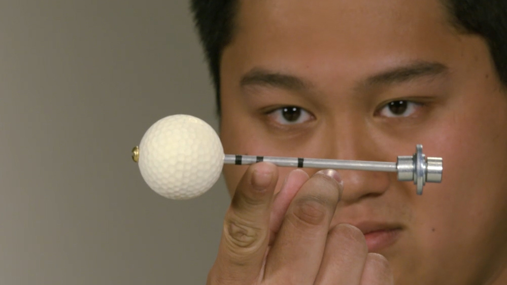 The picture shows the rod with unequal weights on its ends placed on ...